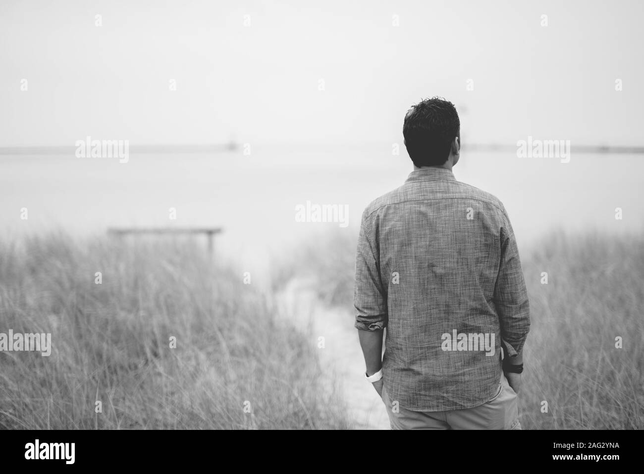 One man standing from behind Black and White Stock Photos & Images - Alamy