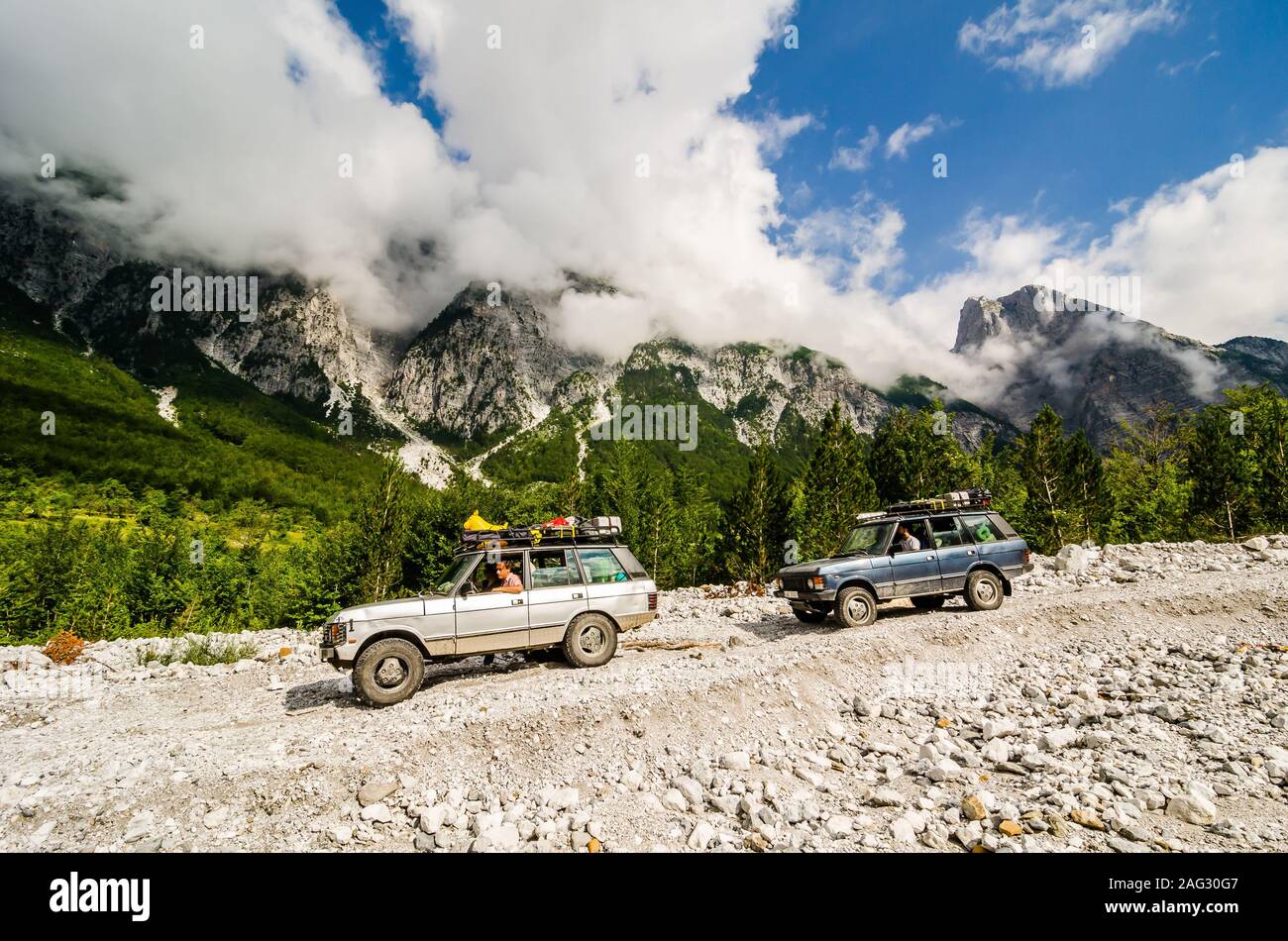 Theth, Albania - July 24, 2014. Two vintage off road cars on the dirt ...