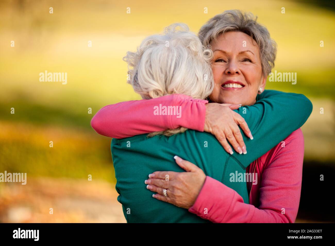 Two old friends hugging each other hi-res stock photography and images ...