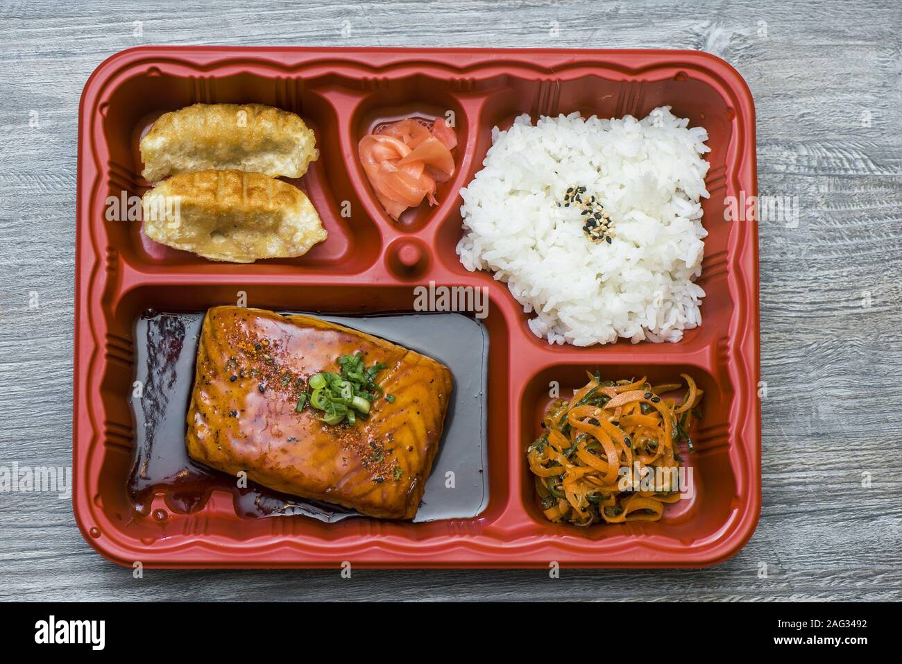 High angle shot of a plate of seafood and rice on a wooden surface ...