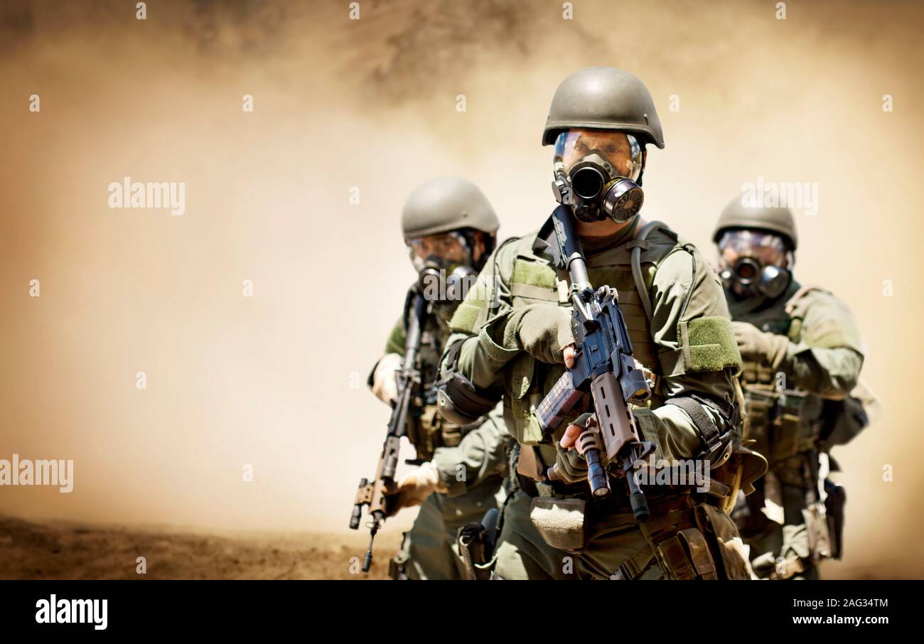 Armed soldiers on duty in the desert Stock Photo - Alamy