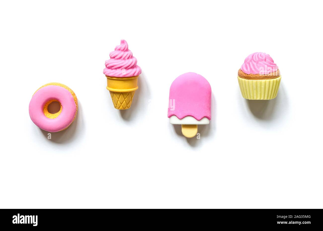 Different toy sweets in miniature with soft shadows close-up isolated ...