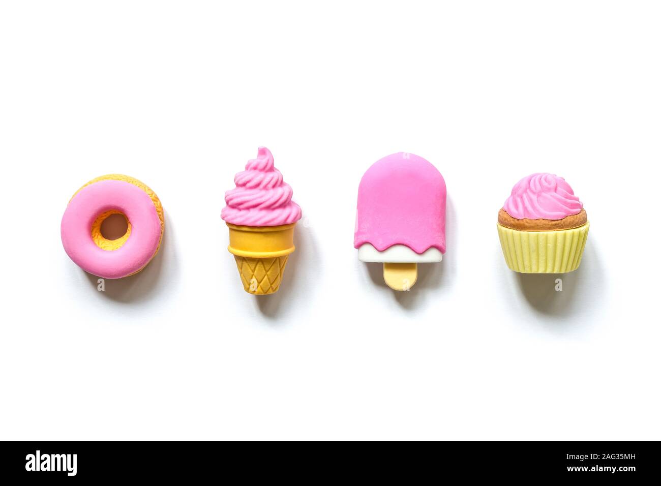 Different toy sweets in miniature with soft shadows close-up isolated ...