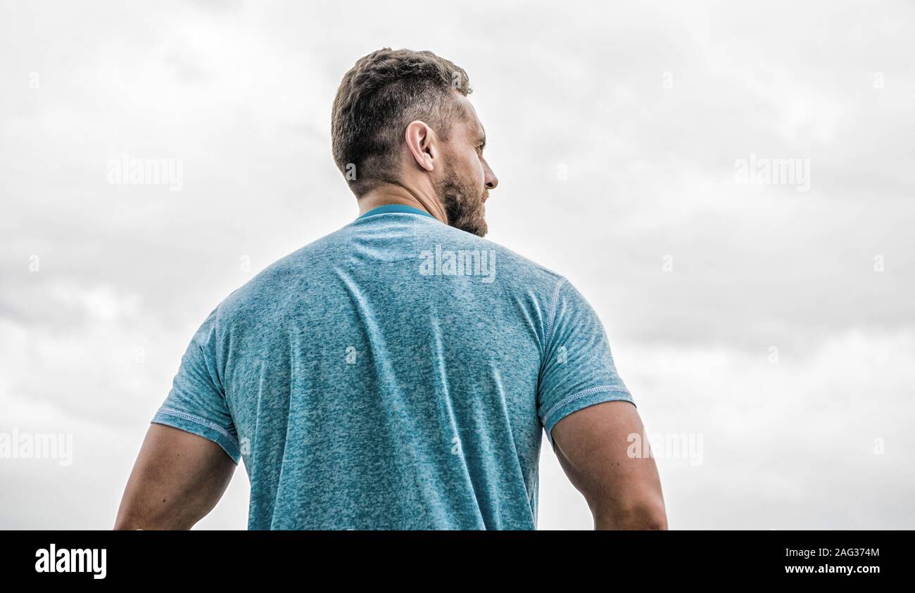 Strong muscular body feeling powerful rear view. Successful athlete ...