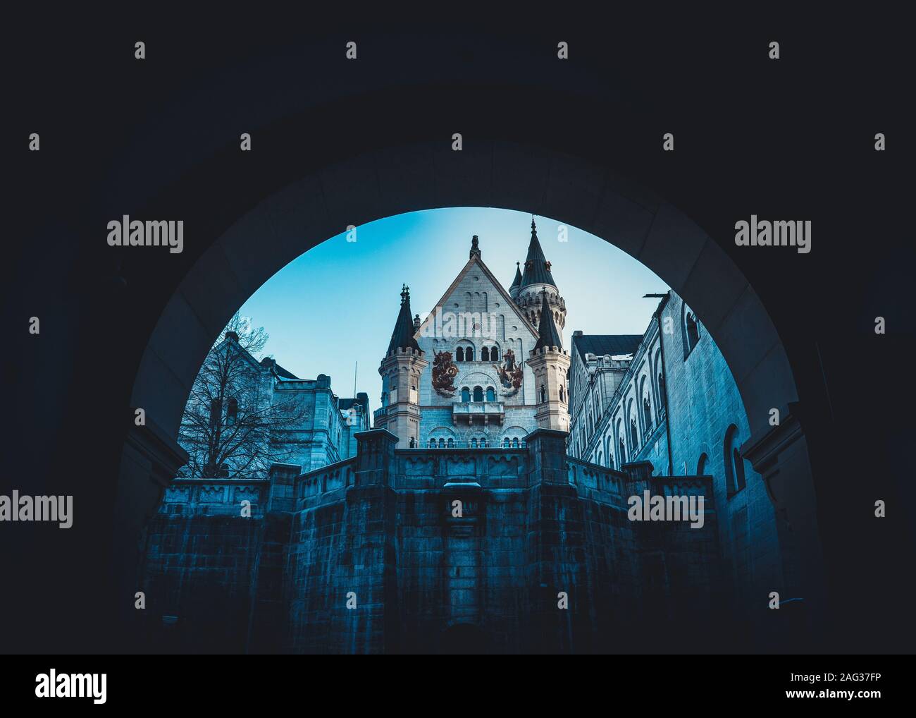 Low angle shot of a beautiful white castle from the inside of an arch ...