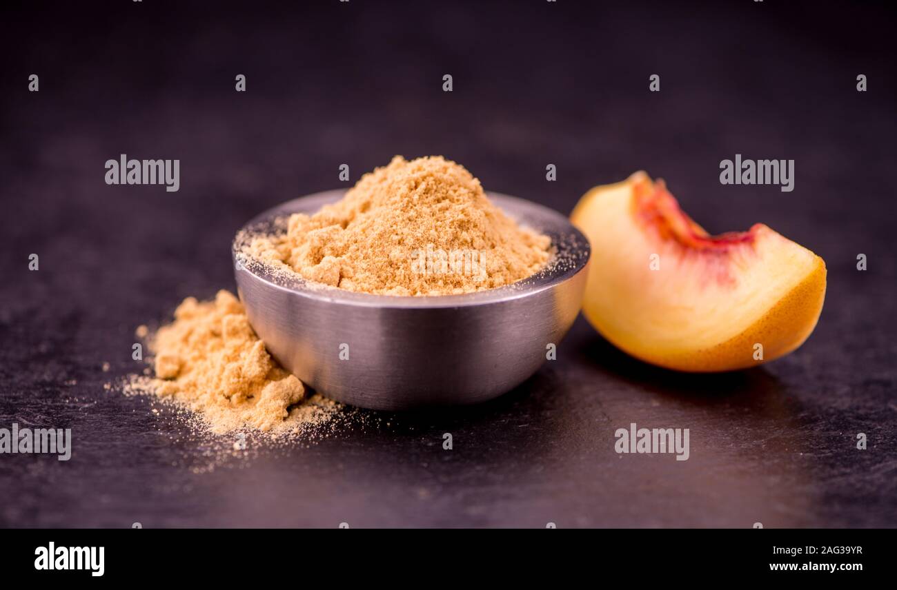 Peach powder on a vintage slate slab as detailed close-up shot ...