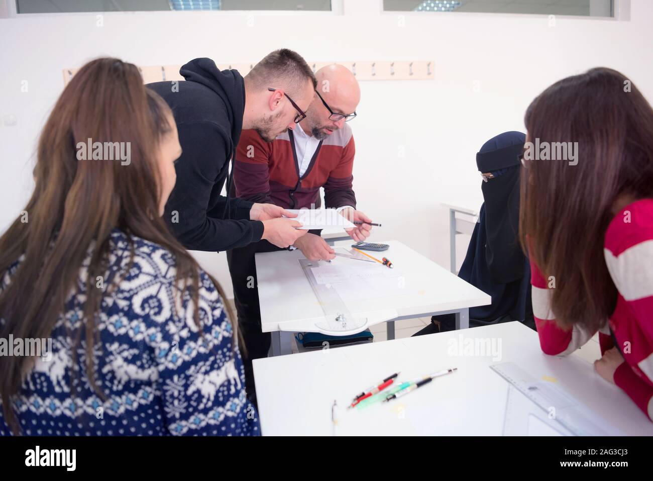 Male professor of architecture explain lesson to multiethnic students ...