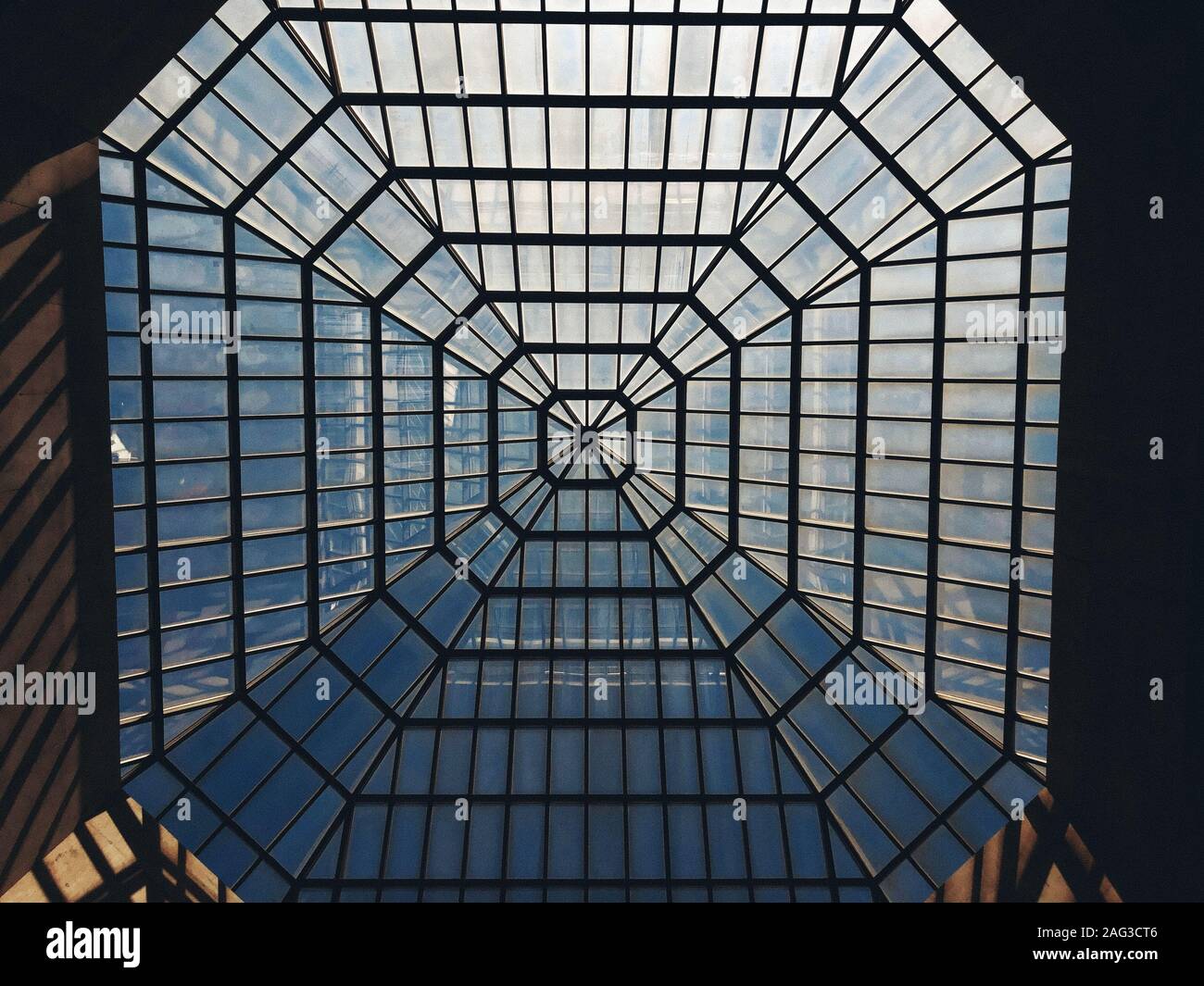 Low angle shot of a ceiling with see-through windows and sun rays ...