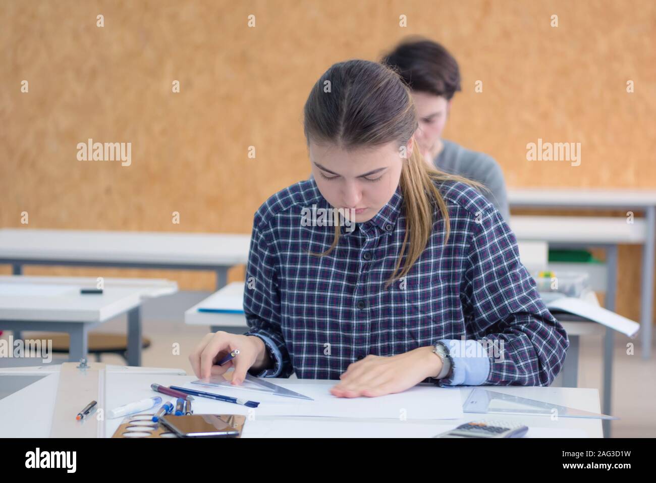 Pretty female university architecture student working on practice ...