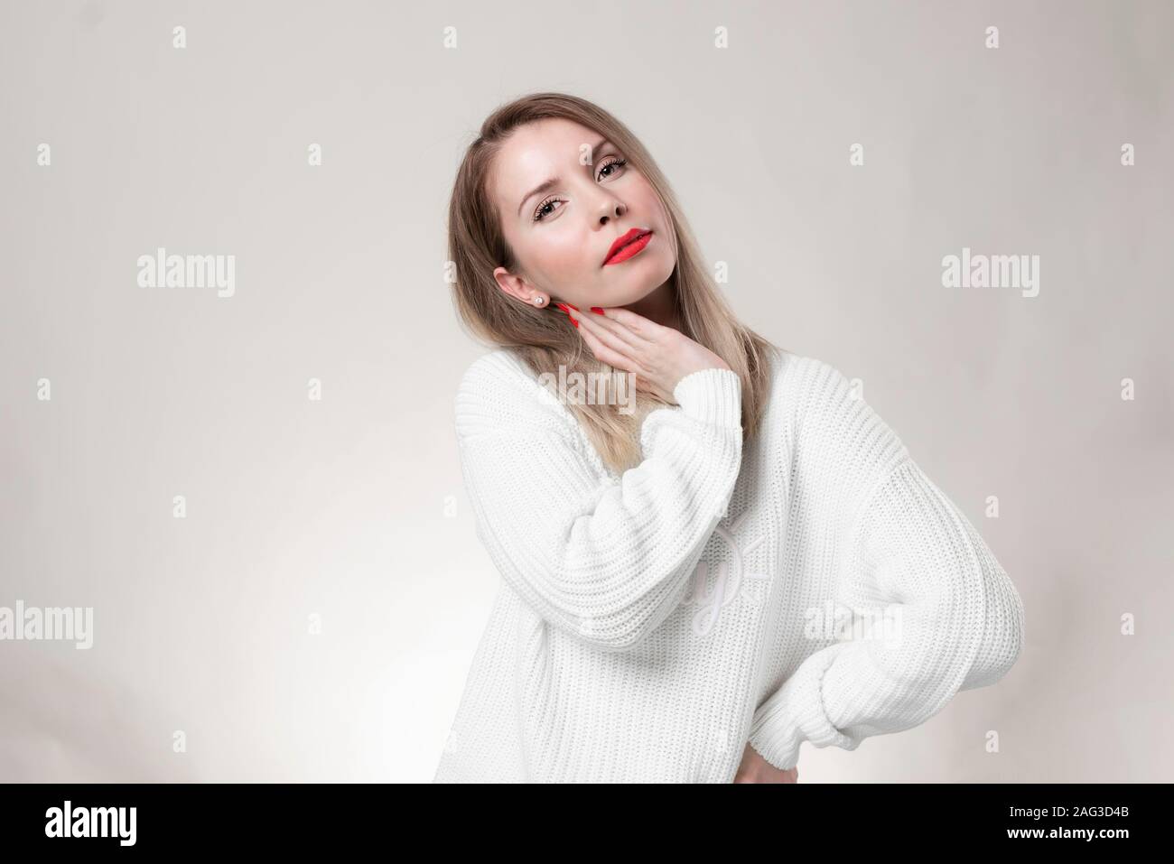 Woman with red lips and nails surprise holds cheeks by hand .Beautiful ...