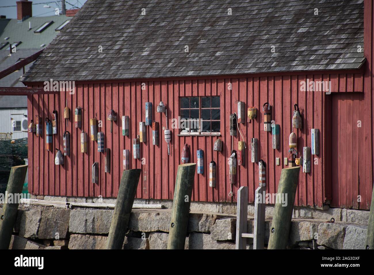 Wooden pink village house with a dark roof with a cool design on the ...
