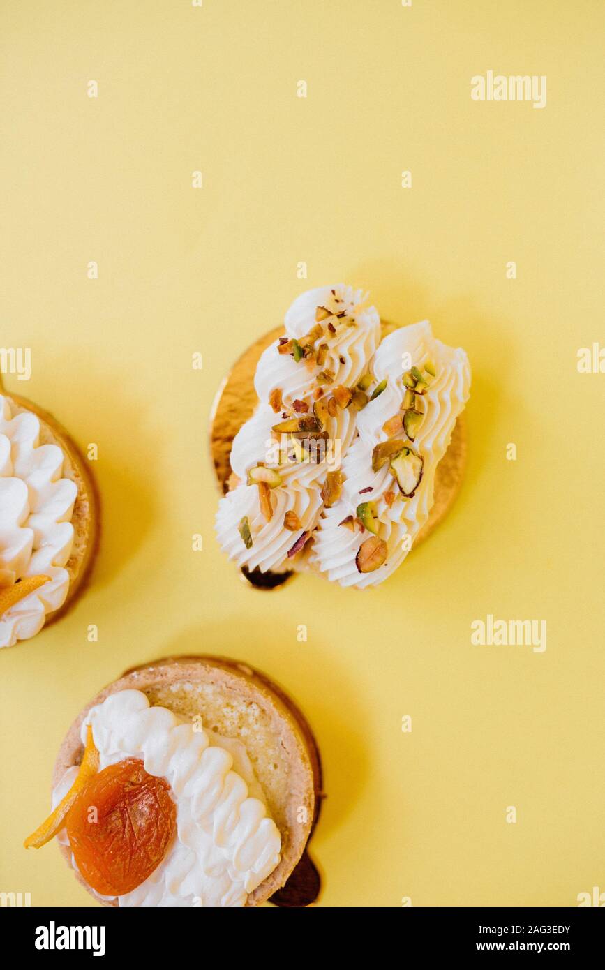 A high angle shot of different kinds of pastries on yellow surface ...
