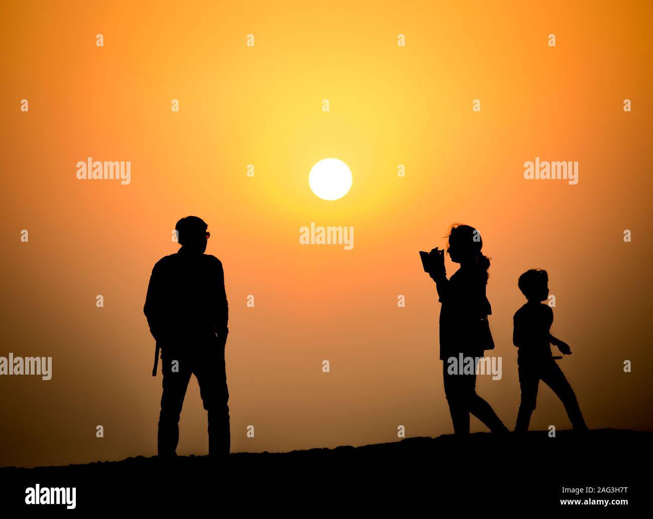 People in silhouette at sunset. Taken at Lions Point, near Lonavala, in ...