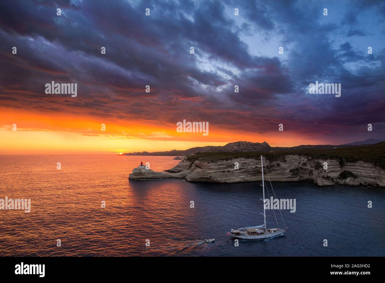 Lighthouse by the ocean with a beautiful sunset in the background Stock ...