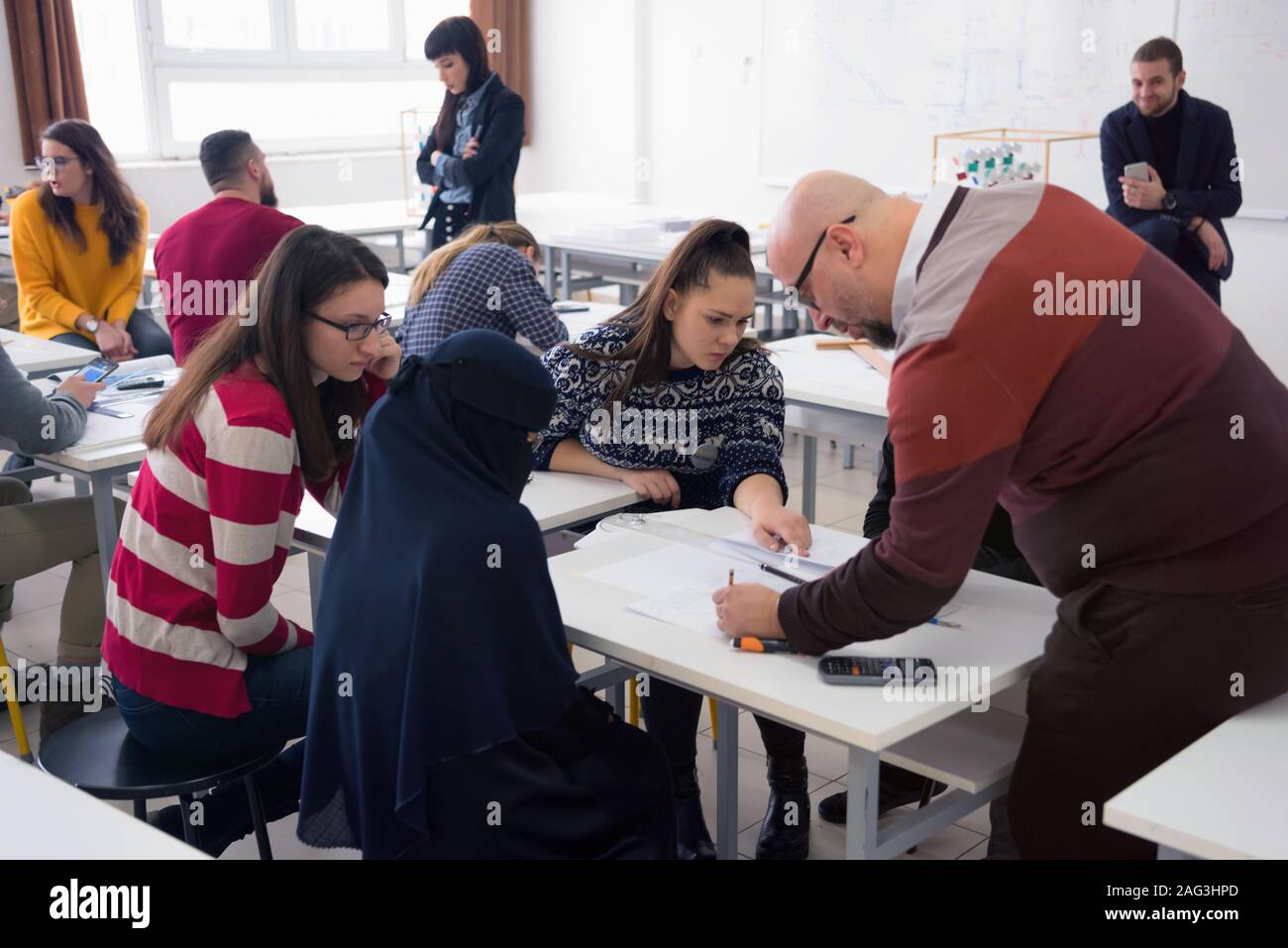 Male professor of architecture explain lesson to multiethnic students ...