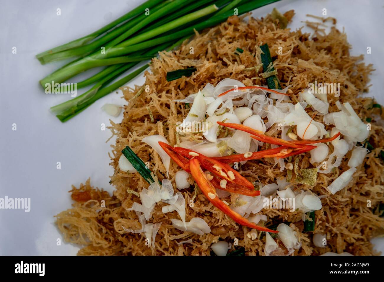 Asian eating food, Mee Grob is an sweet and sour crispy noodles, made ...