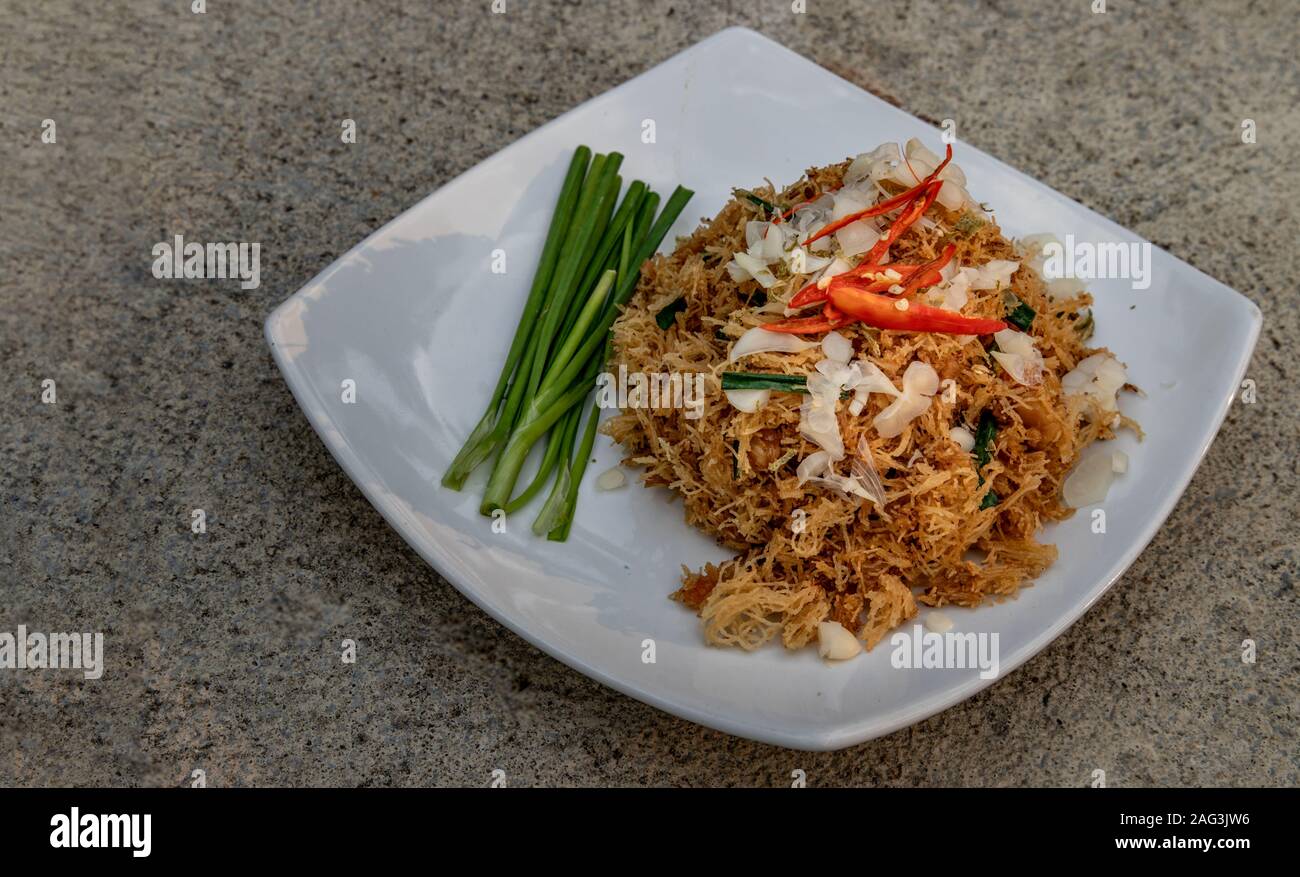 Asian eating food, Mee Grob is an sweet and sour crispy noodles, made ...