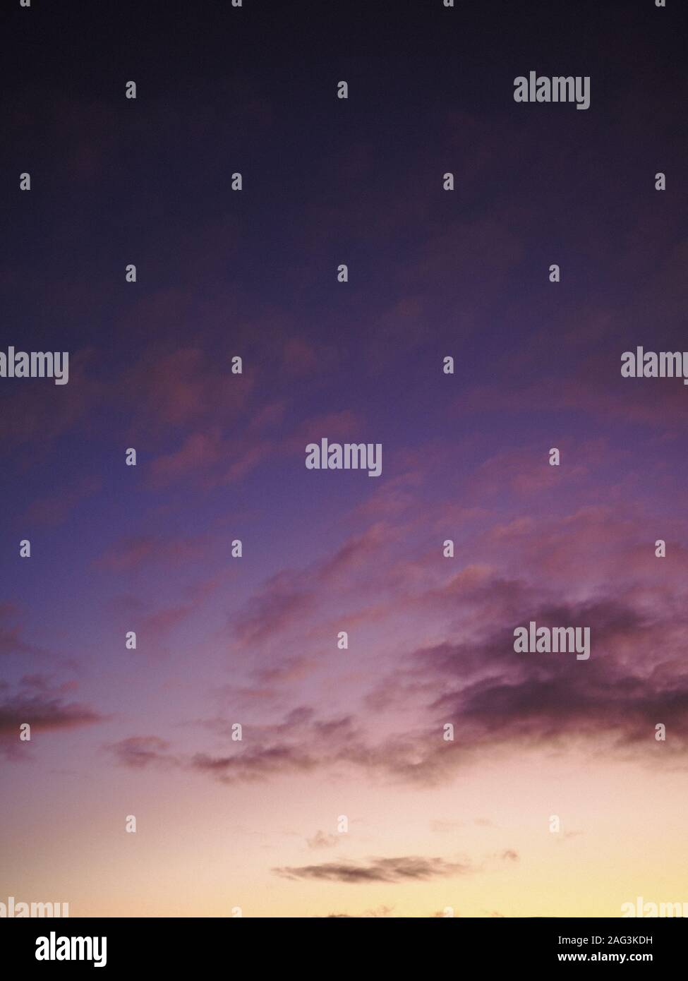 Vertical shot of the colorful sky with clouds changing shades Stock ...