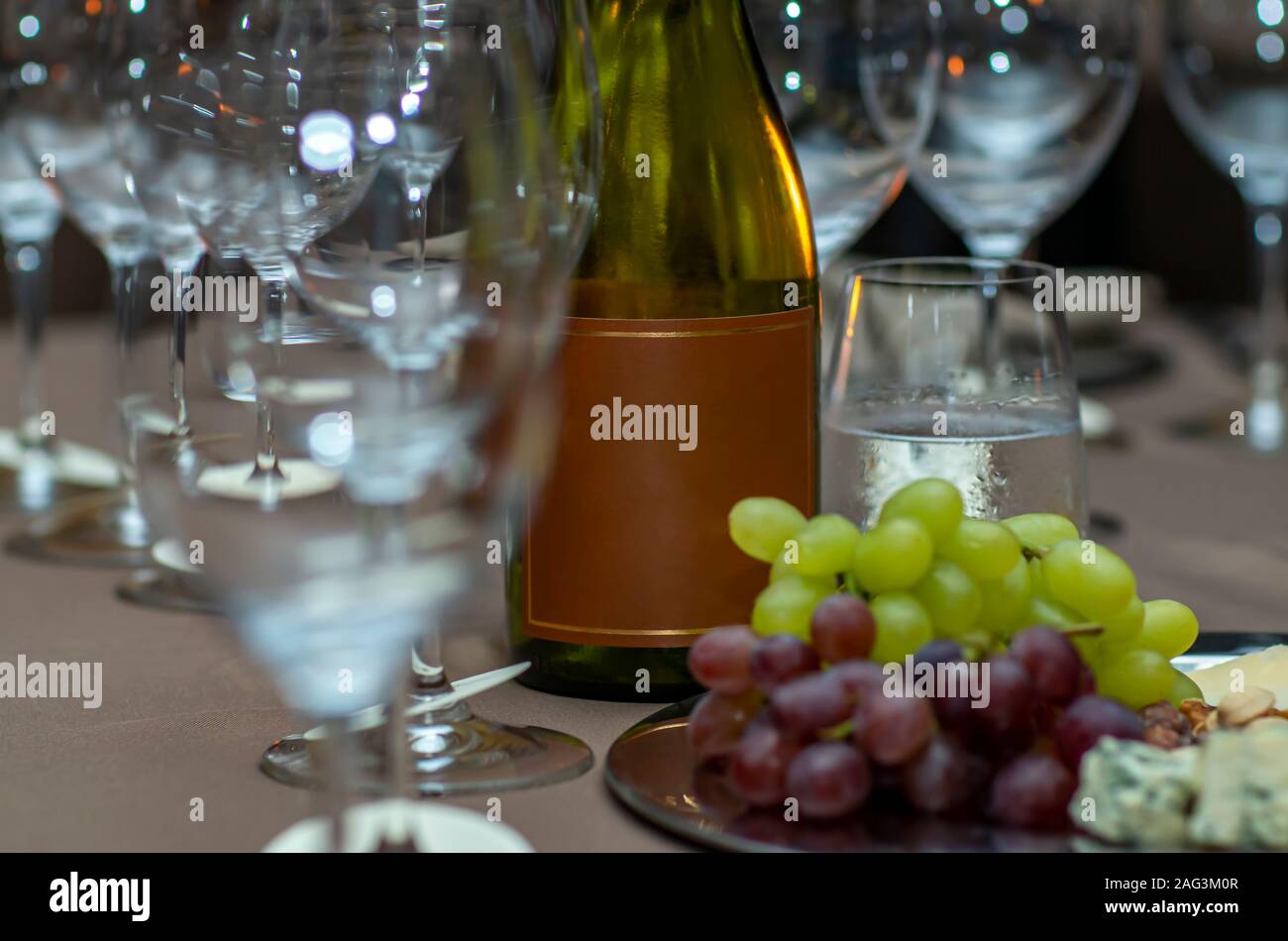 Wine bottle and cheese variety for snack Stock Photo - Alamy