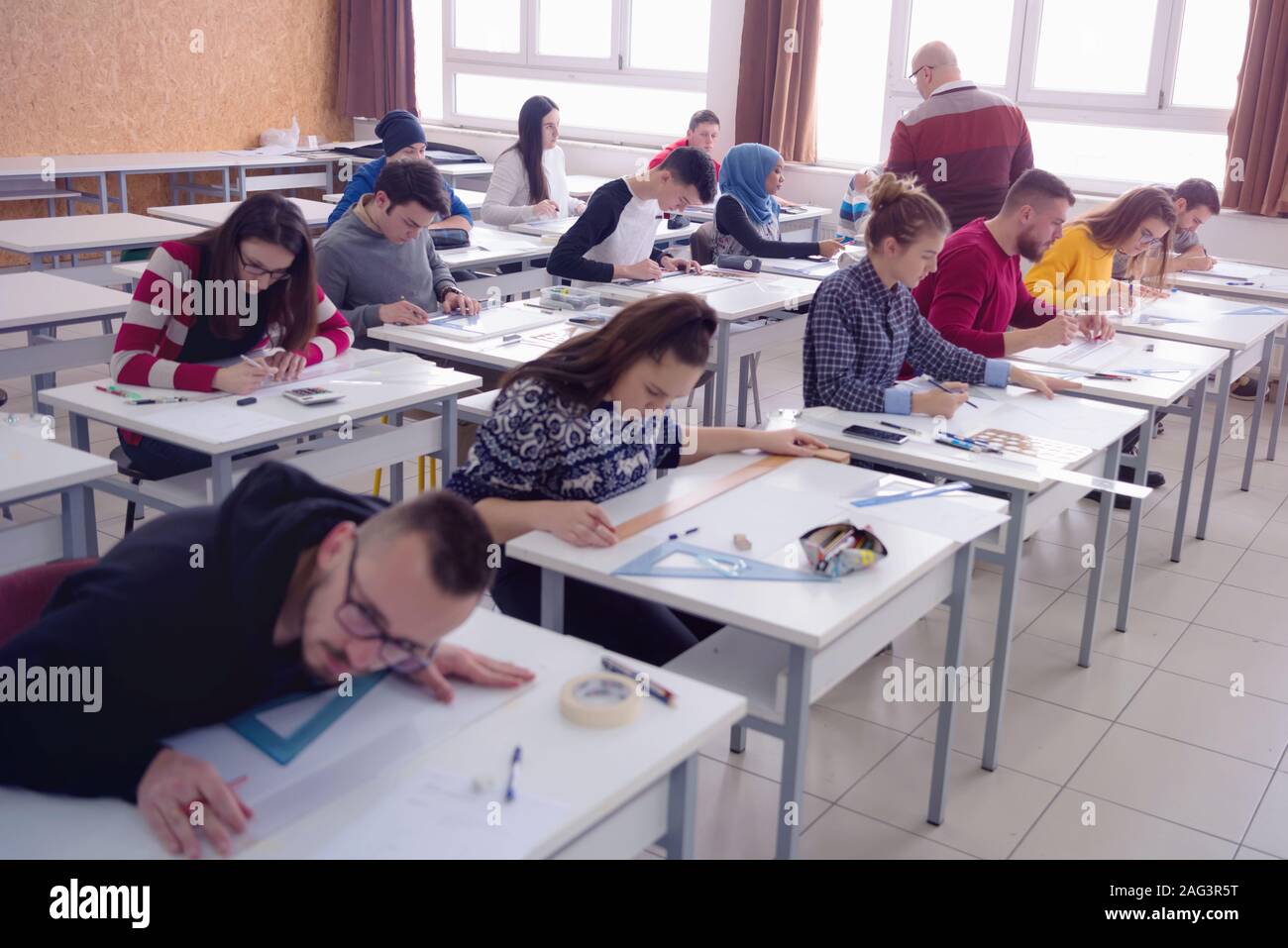 Male professor of architecture explain lesson to multiethnic students ...