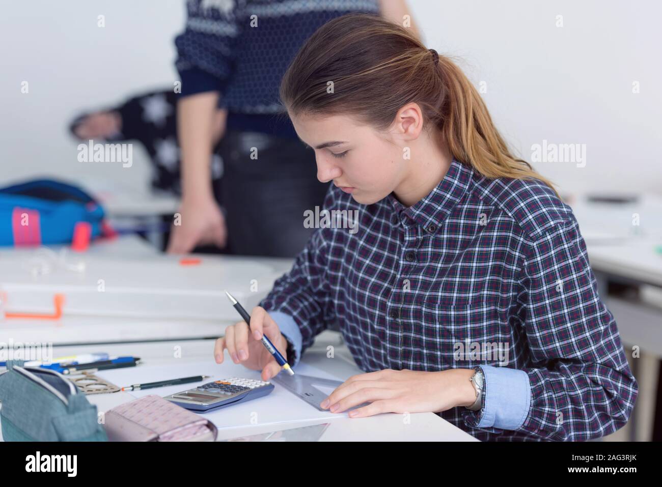 Pretty female university architecture student working on practice ...
