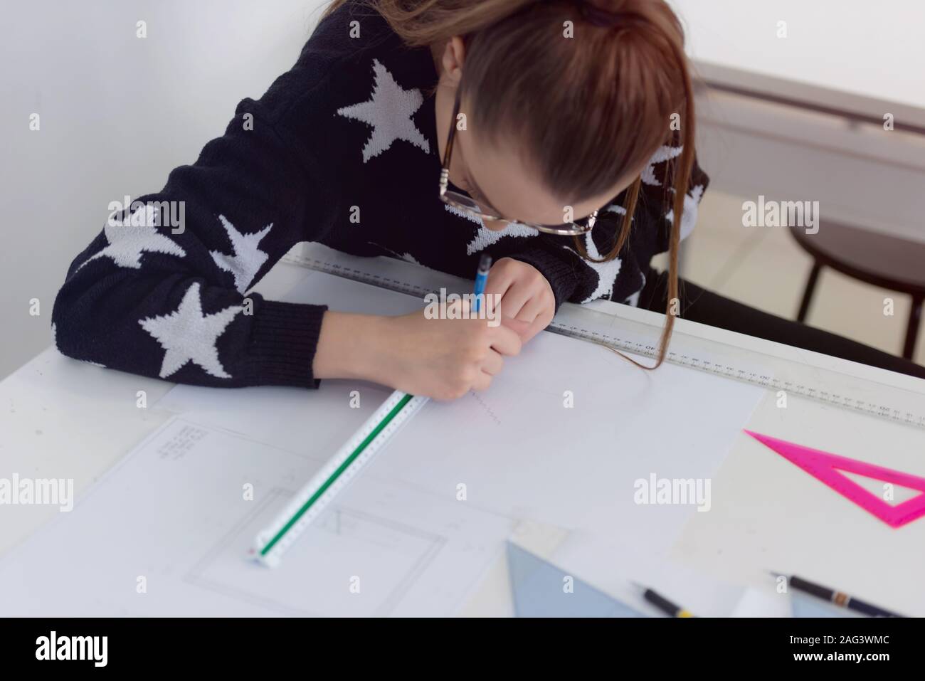 Female university architecture student working on practice lessons ...