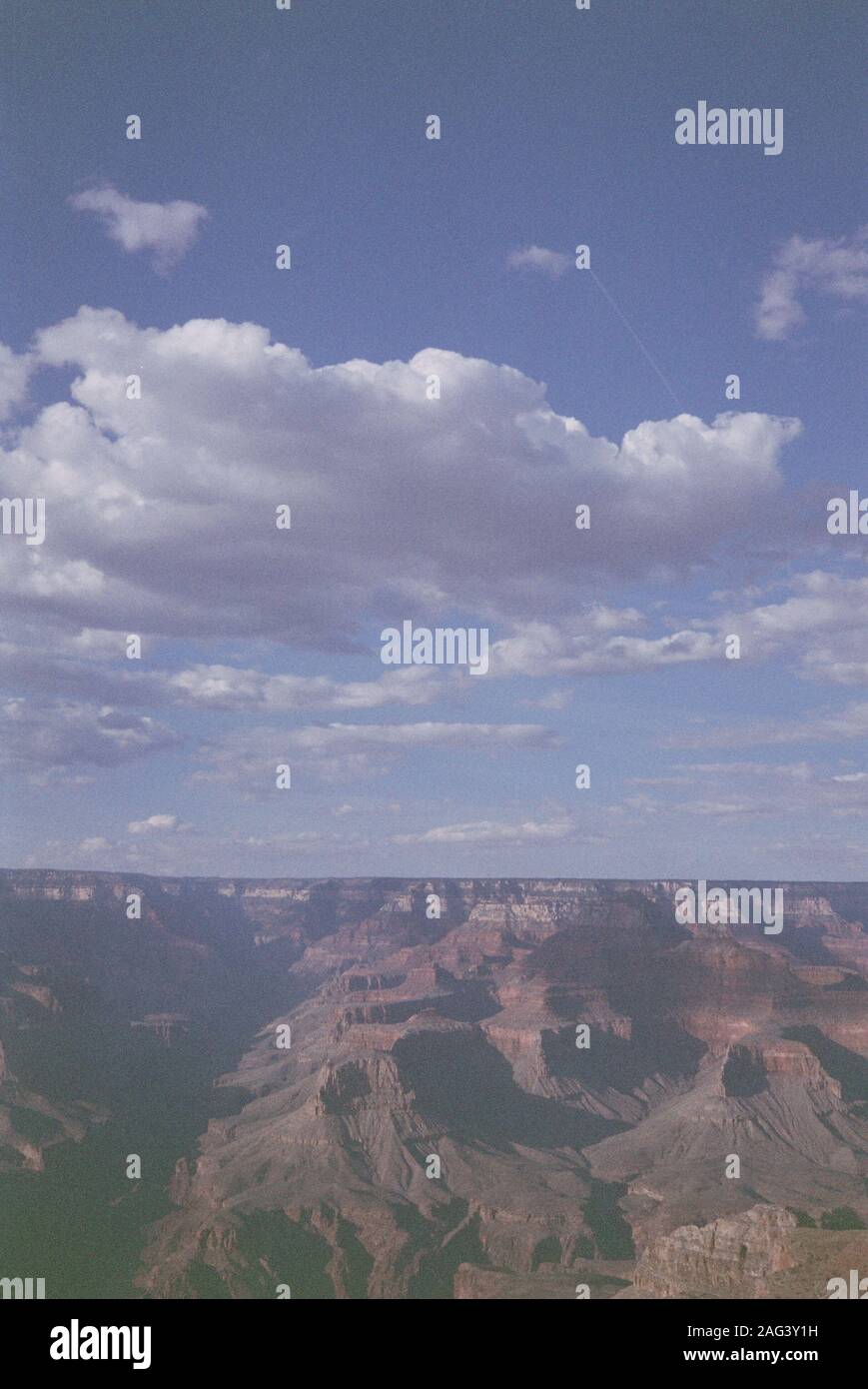 Vertical high angle shot of canyons enveloped in fog under the ...
