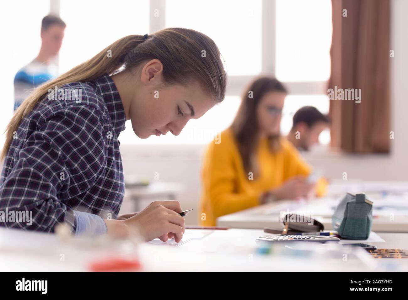 Pretty female university architecture student working on practice ...