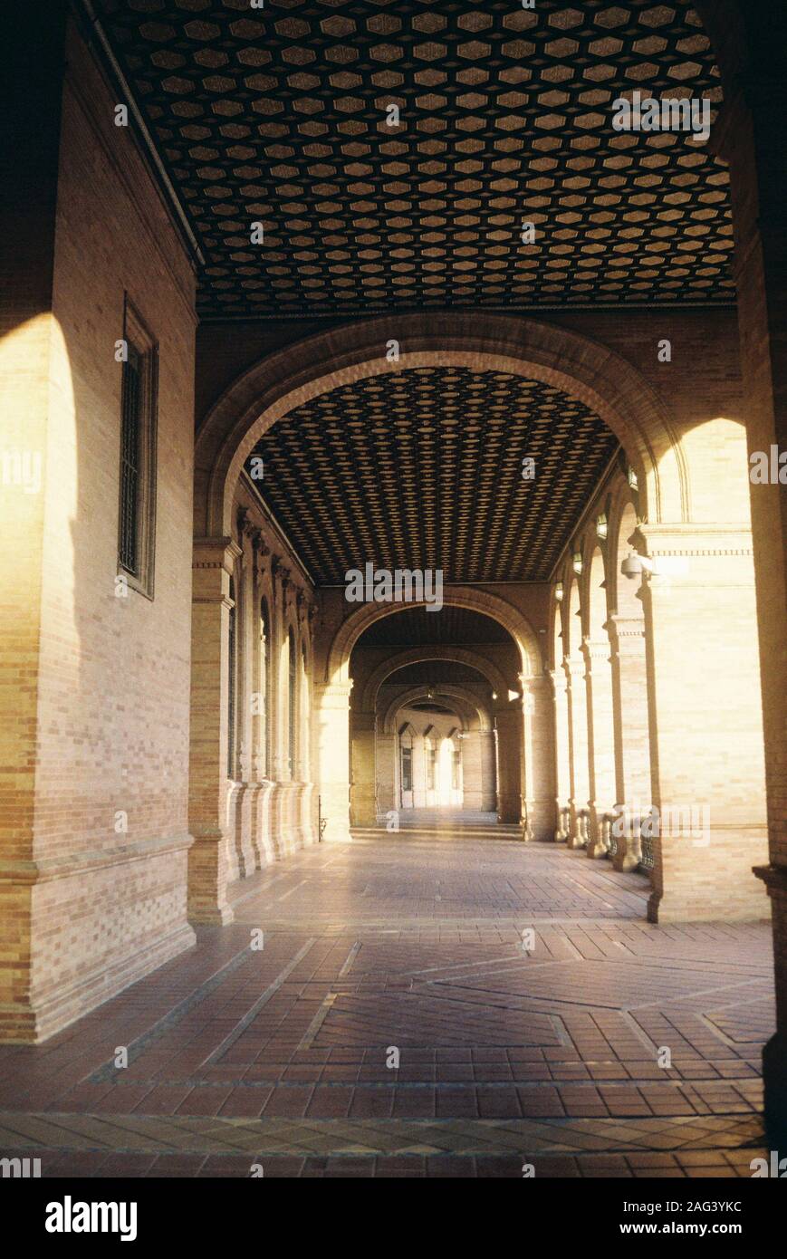 Vertical shot of arches inside a building with beautiful sun rays ...