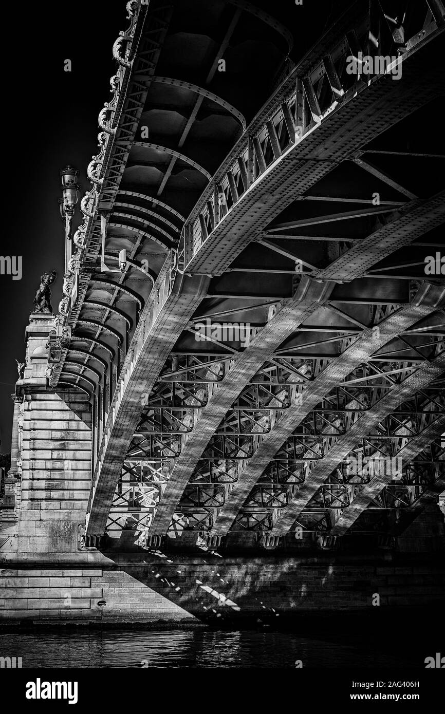 Vertical gray scale shot of under a bridge over a river Stock Photo - Alamy