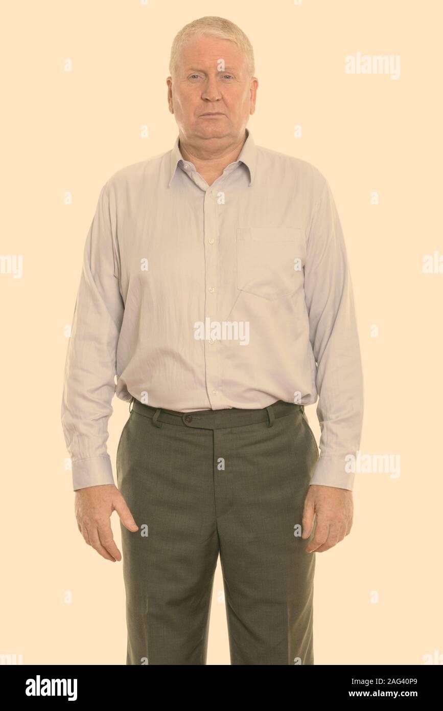 Studio shot of mature man standing Stock Photo - Alamy