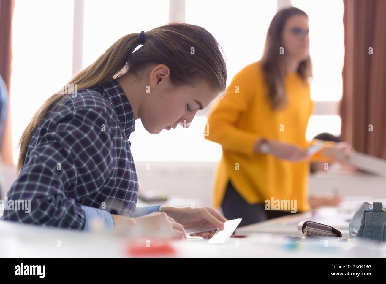 Pretty female university architecture student working on practice ...