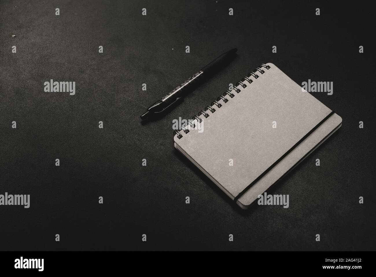 Gray scale high angle shot of a notebook and a pen Stock Photo - Alamy