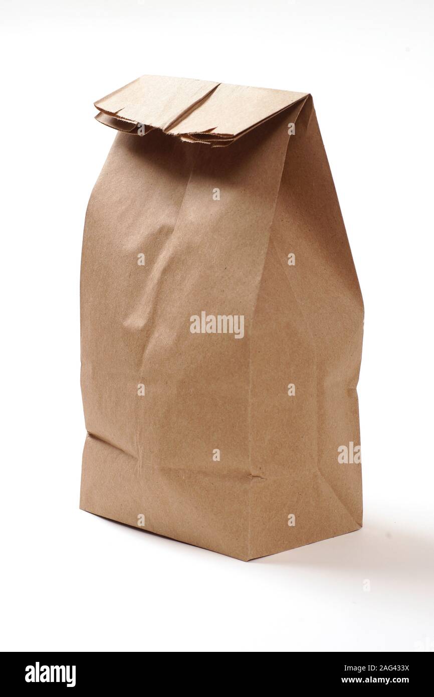 Blank full paper bag folded closed at the top, isolated on white Stock ...