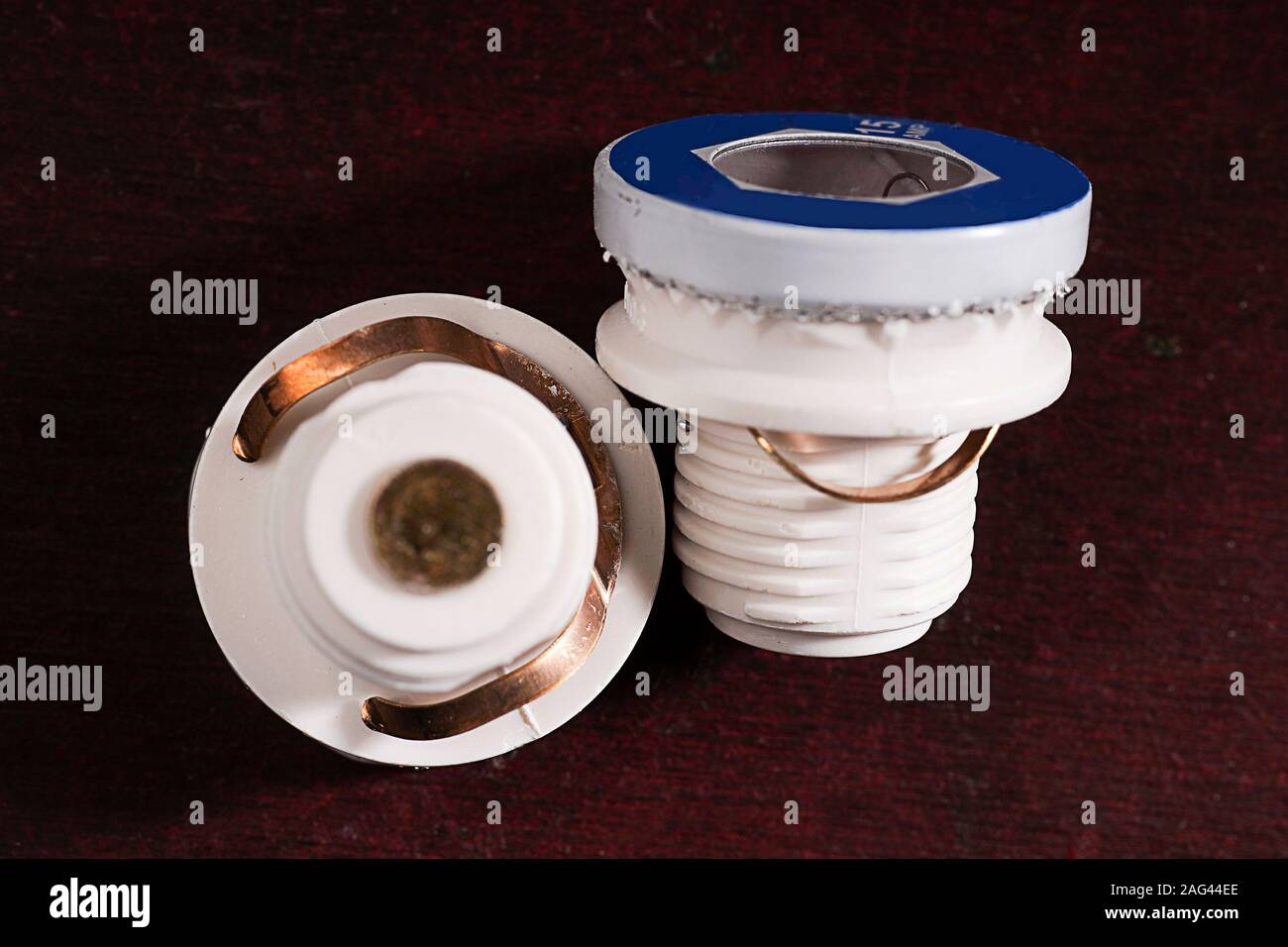 Electrical screw-in fuses on dark red-black background with copy space ...