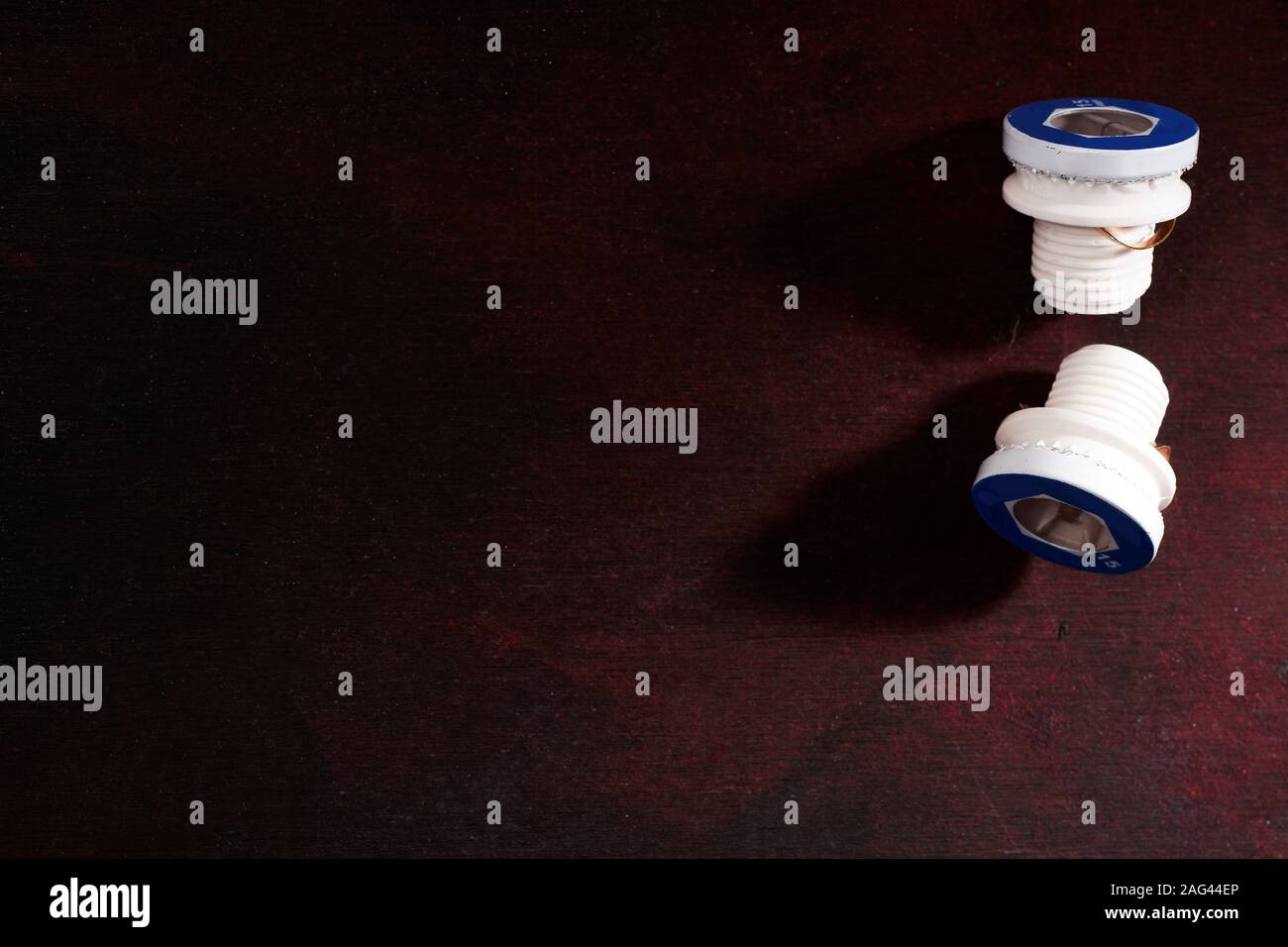 Electrical screw-in fuses on dark red-black background with copy space ...