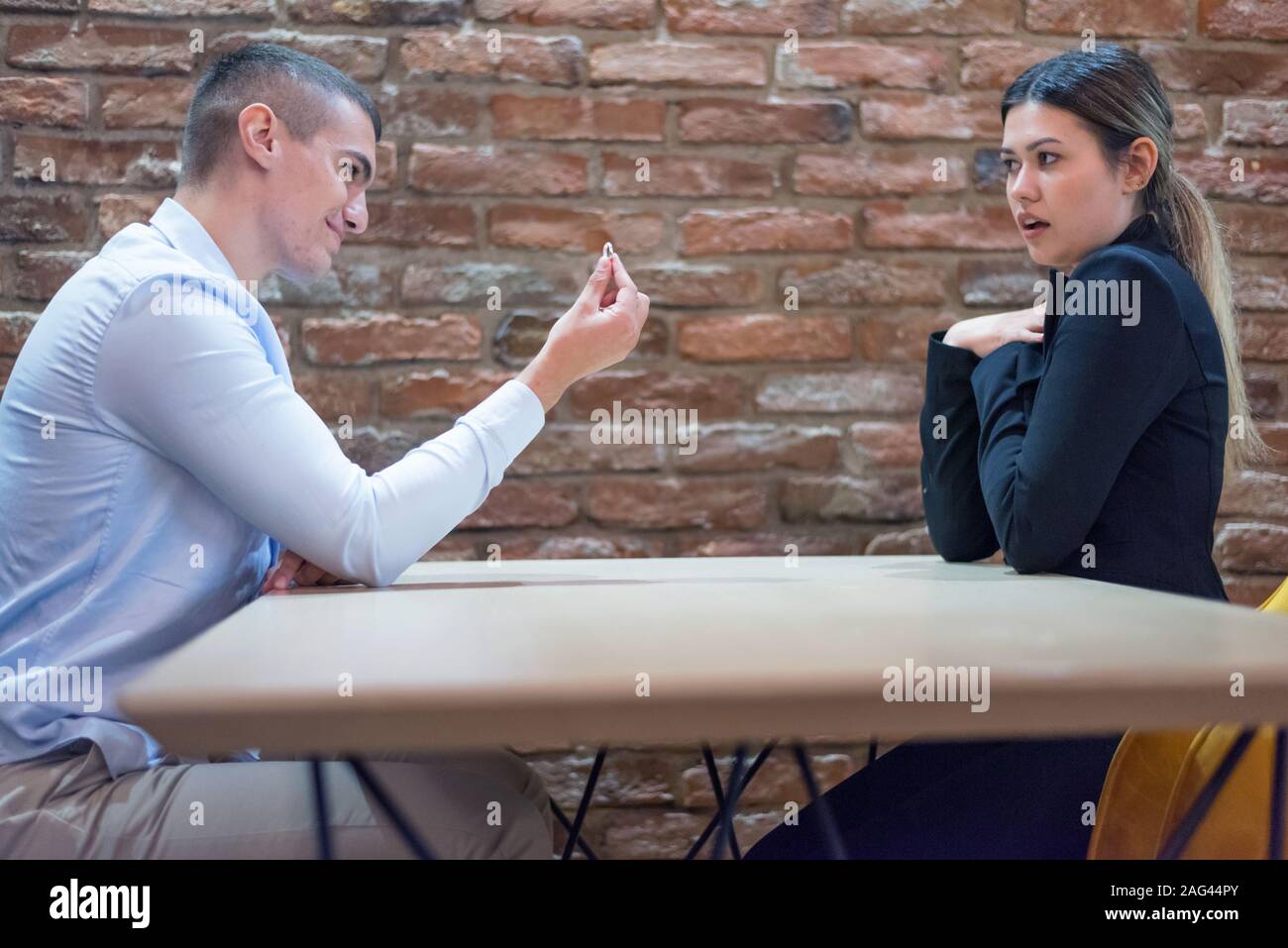 Giving of wedding ring. Man giving an engagement ring to his girlfriend ...