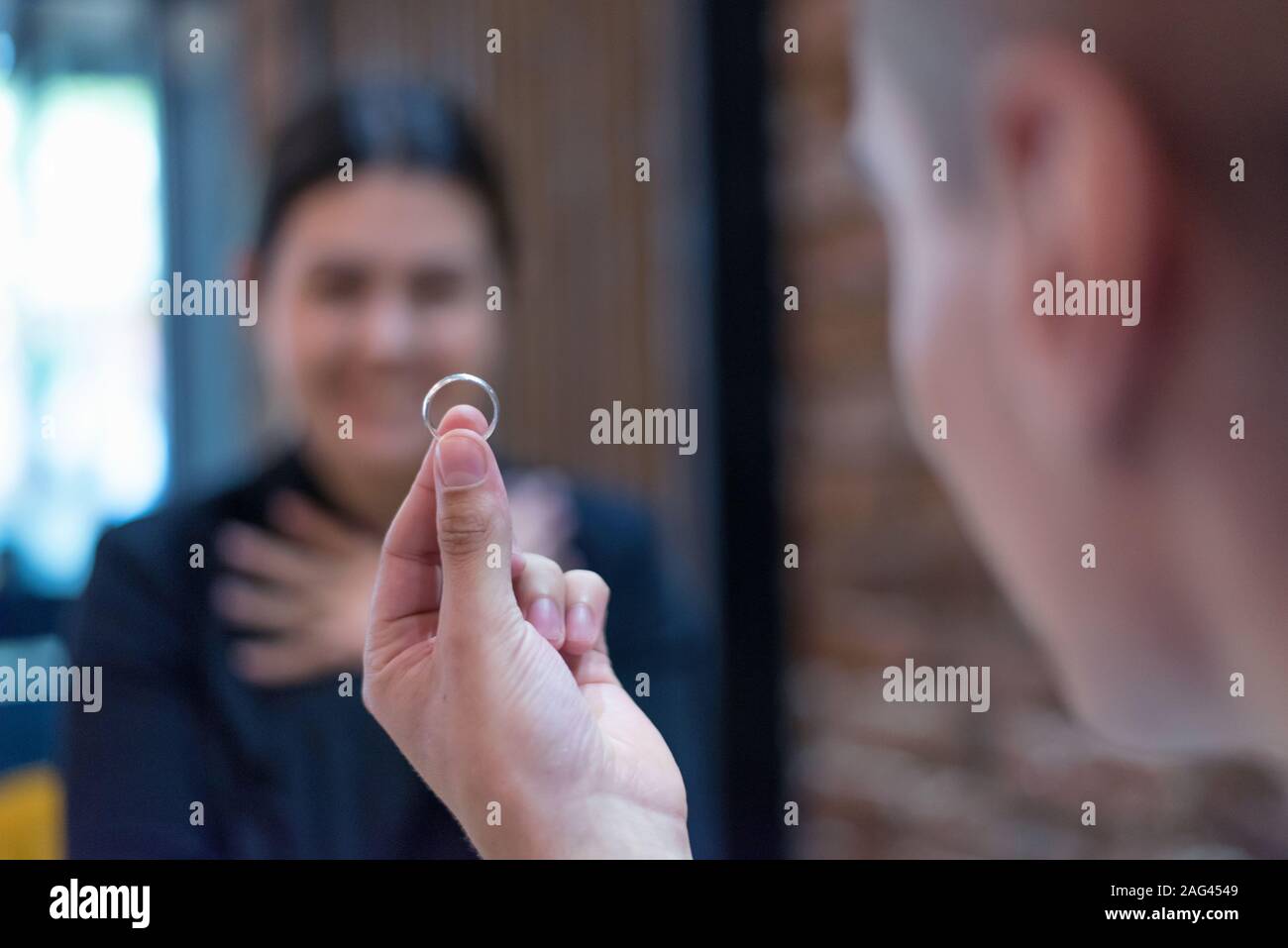 Giving of wedding ring. Man giving an engagement ring to his girlfriend ...