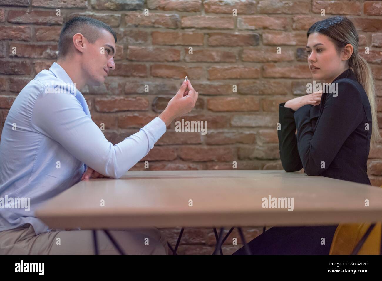 Giving of wedding ring. Man giving an engagement ring to his girlfriend ...