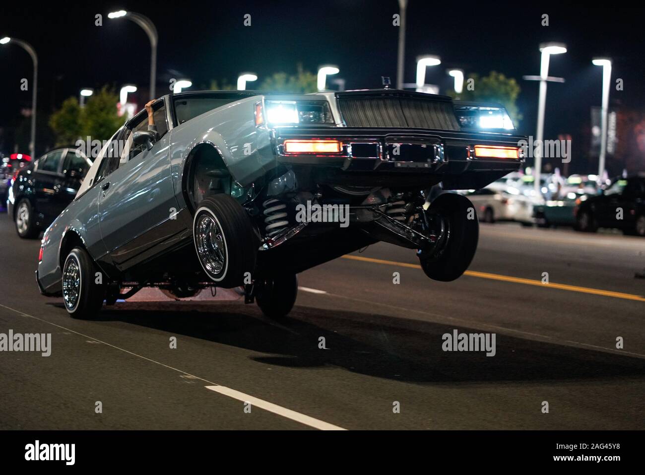Closeup shot of a retro car with only the back wheels on the ground in ...