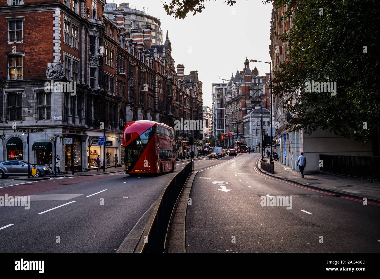 Beautiful shot of a city scene with beautiful buildings and a red bus ...