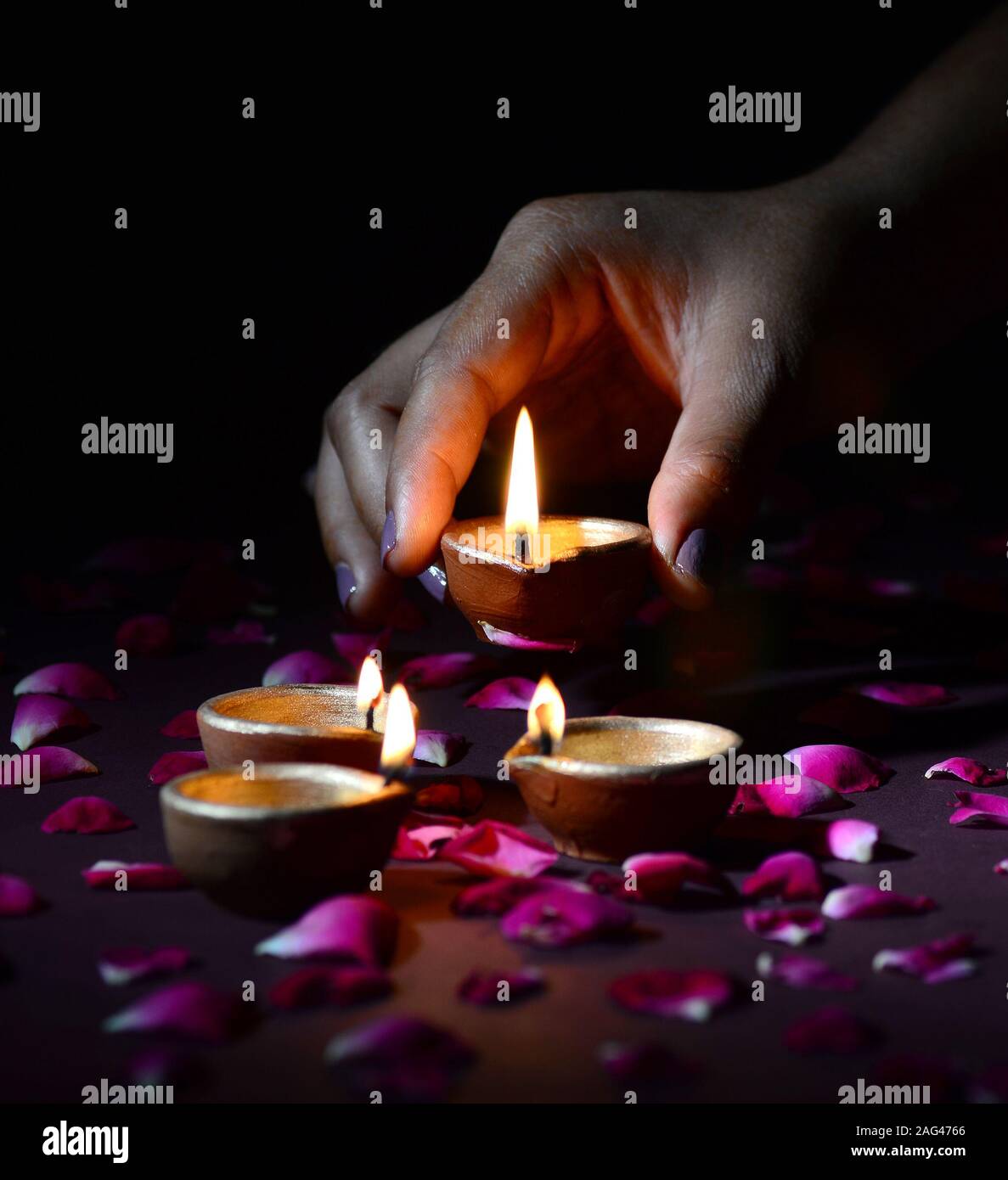 Hand holding and arranging lantern (Diya) during Diwali Festival of ...