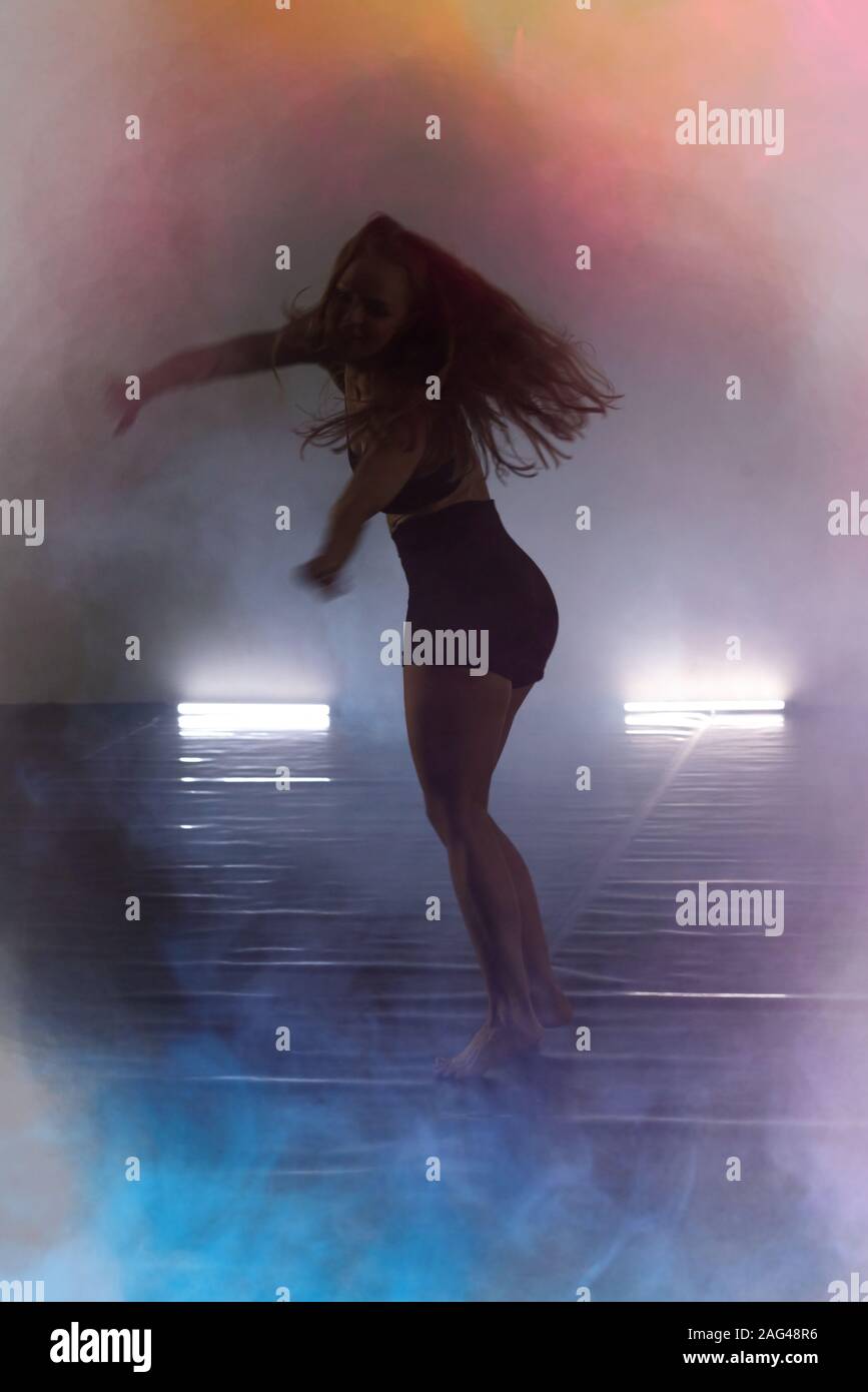 Beautiful Young modern female dancer dancing in the studio. Sport ...