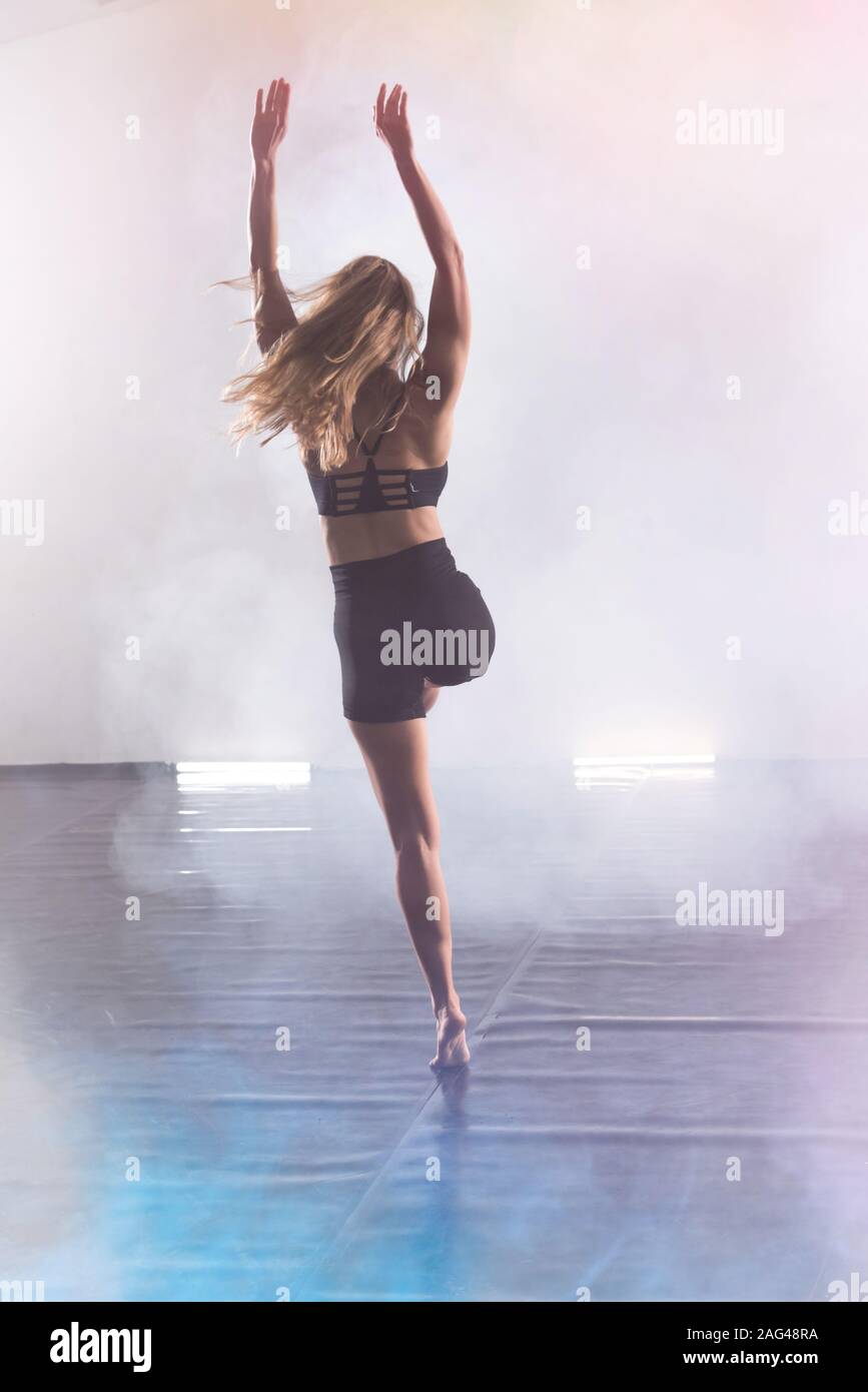 Beautiful Young modern female dancer dancing in the studio. Sport ...