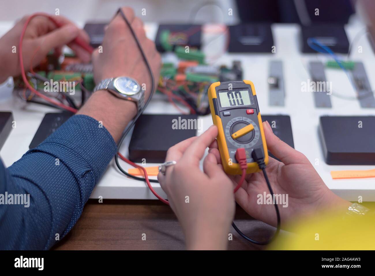 Two young handsome engineers working on electronics components.Tech ...