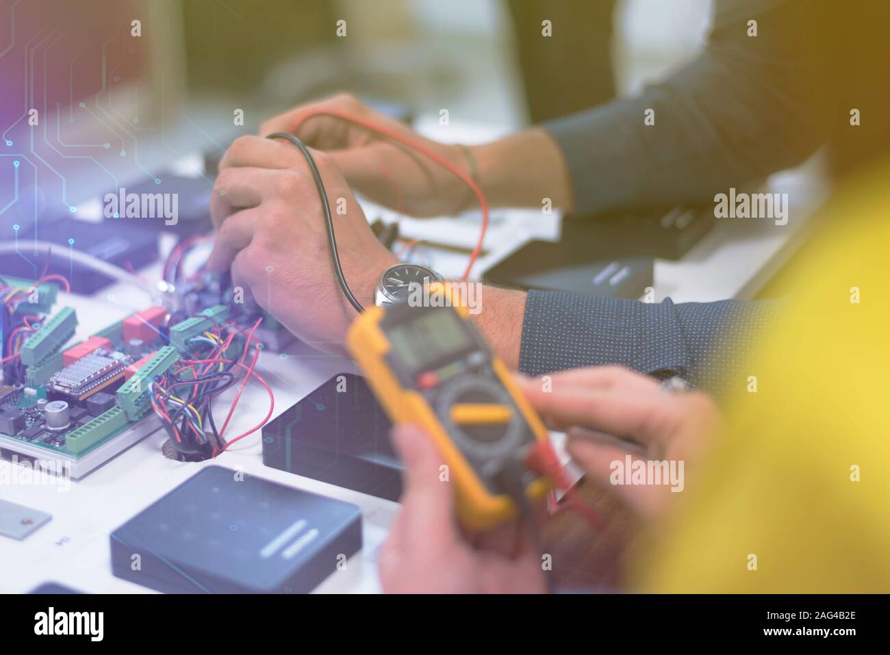 Two young handsome engineers working on electronics components.Tech ...