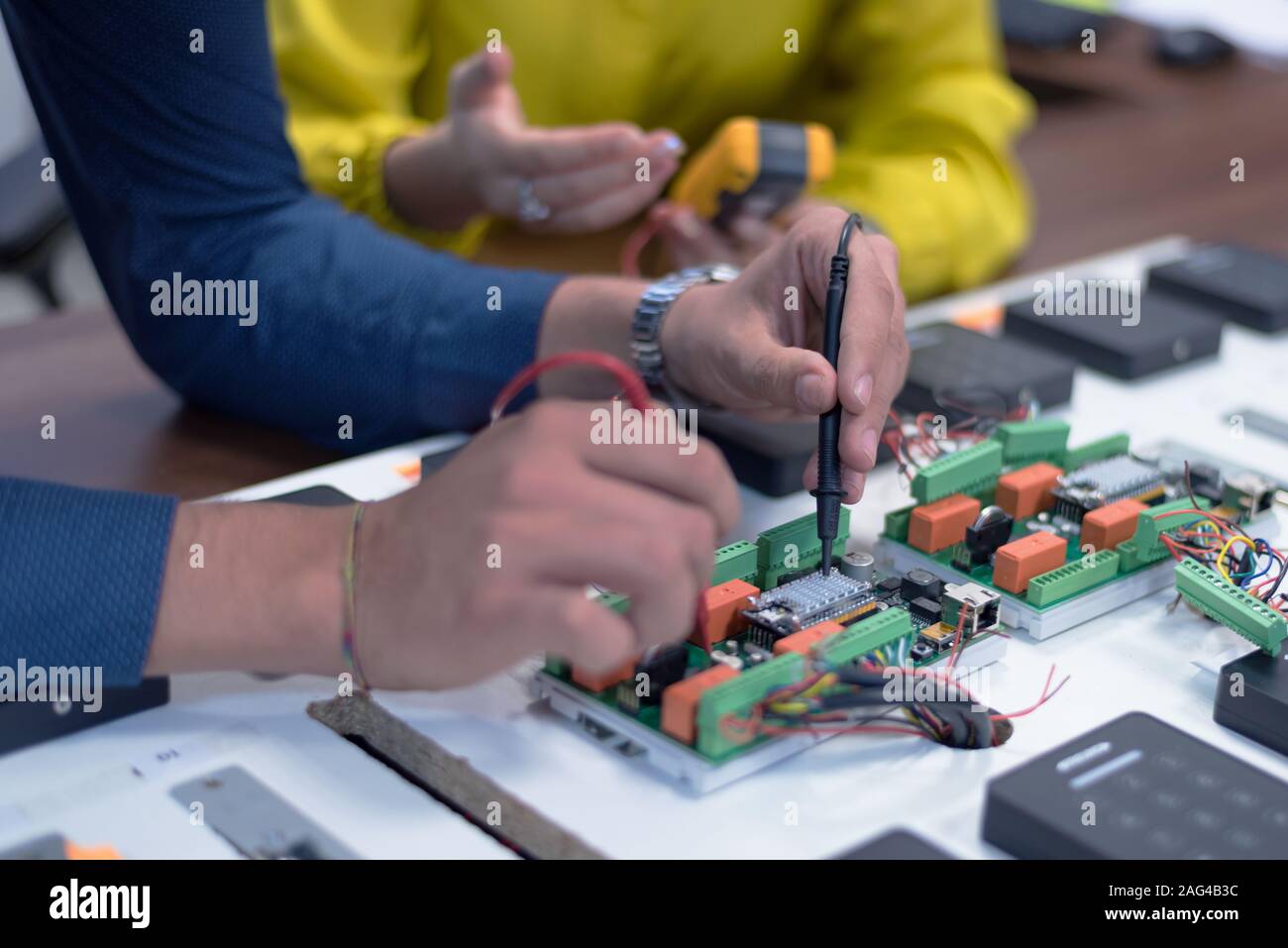 Two young handsome engineers working on electronics components.Tech ...