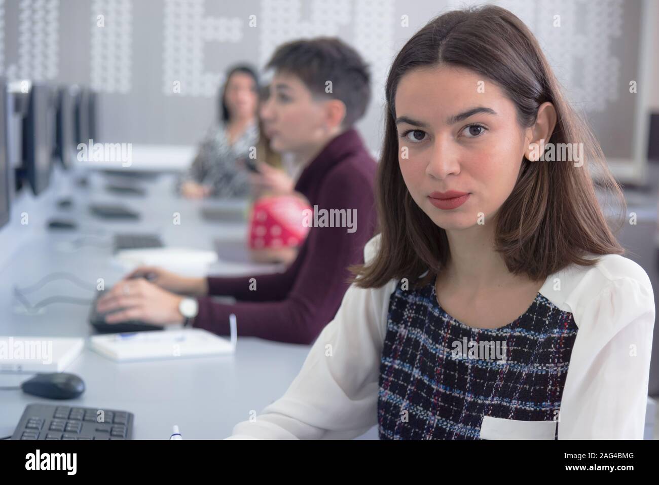 Side view of students using computer in lab. IT student looking and ...