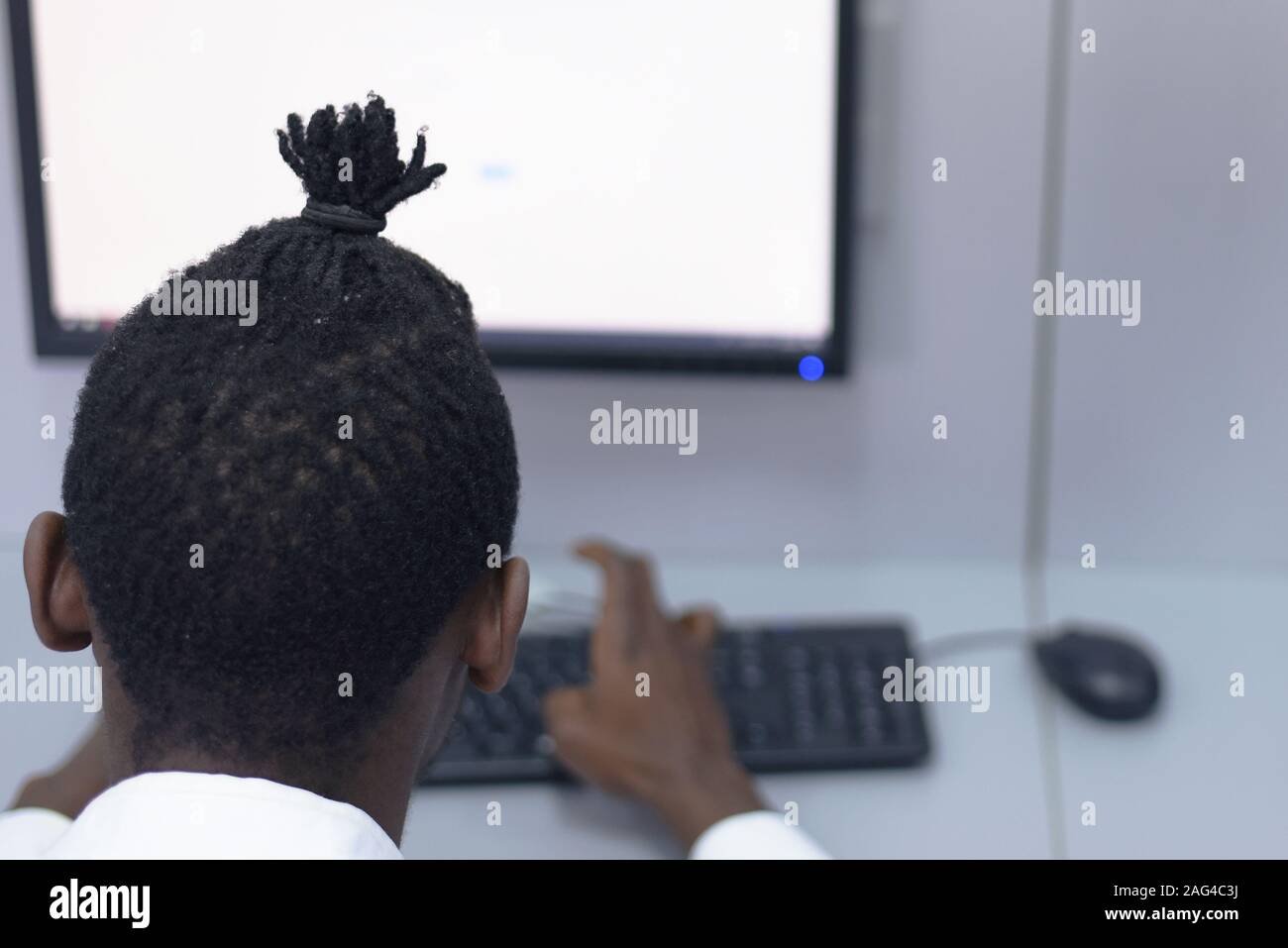 An african american IT student in the computer lab. Students listening ...