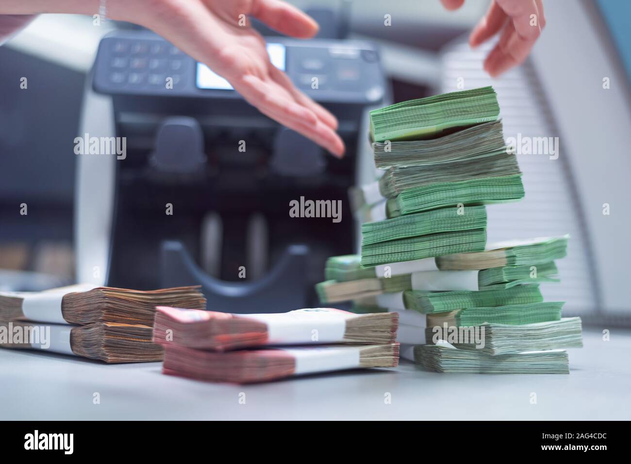 Bank employees sorting and counting money inside bank vault Stock Photo ...